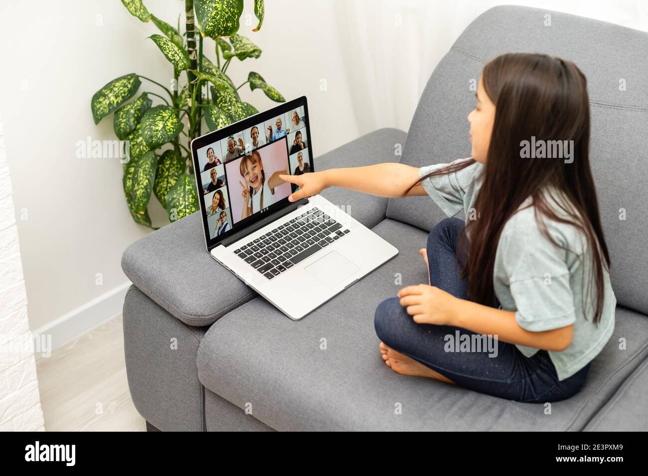 Litttle girl looking at laptop screen with expression of surprised and ...