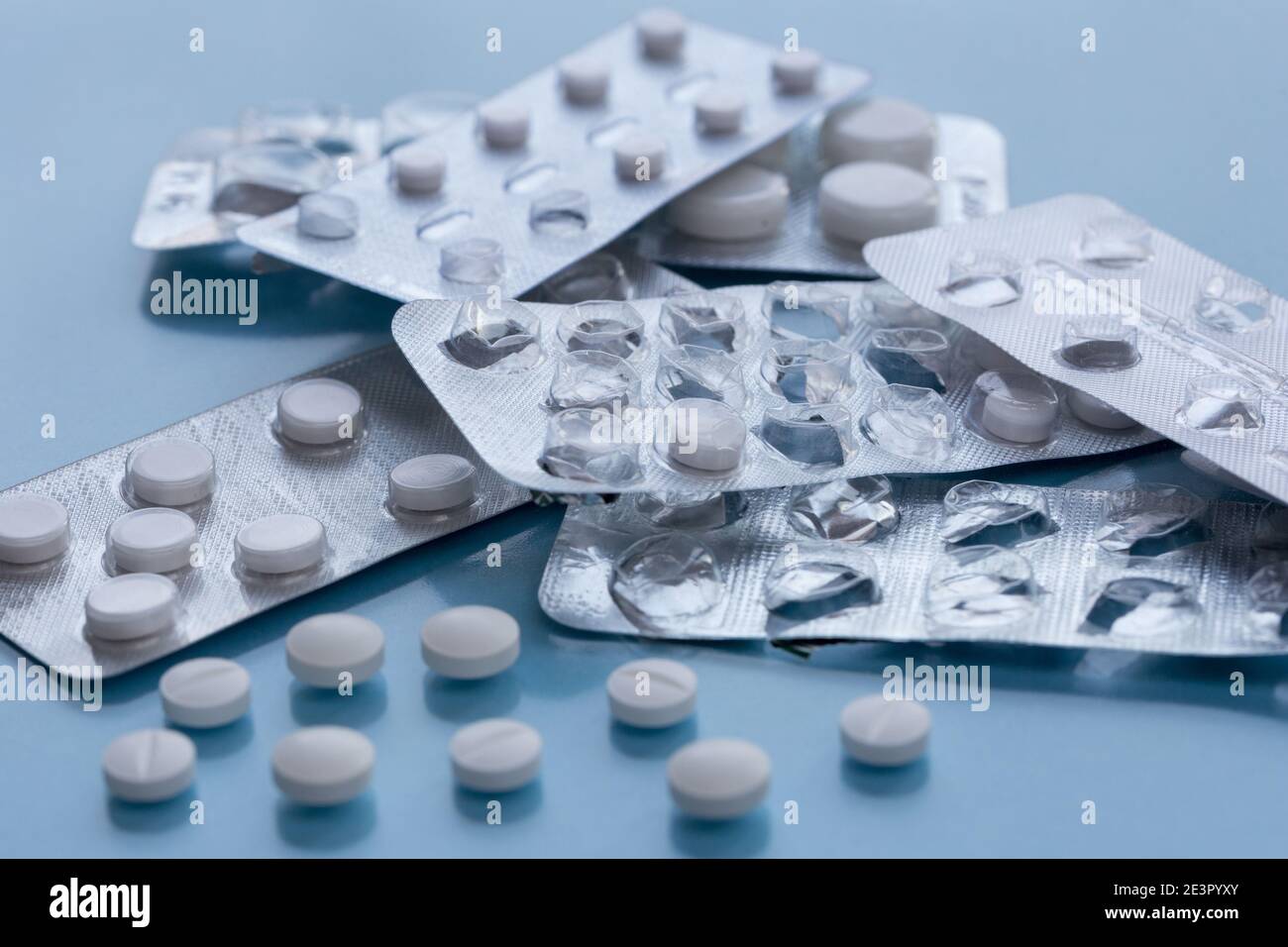 Full and empty pills packagings isolated on blue background. Medical ...