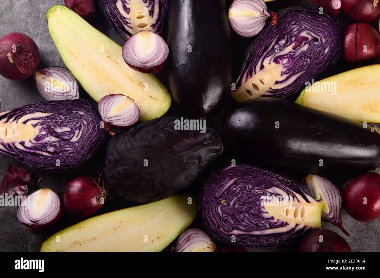 Still life of fresh purple vegetables on a gray background. Collection ...