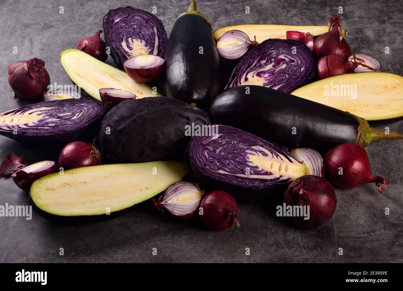 Still life of fresh purple vegetables on a gray background. Collection ...