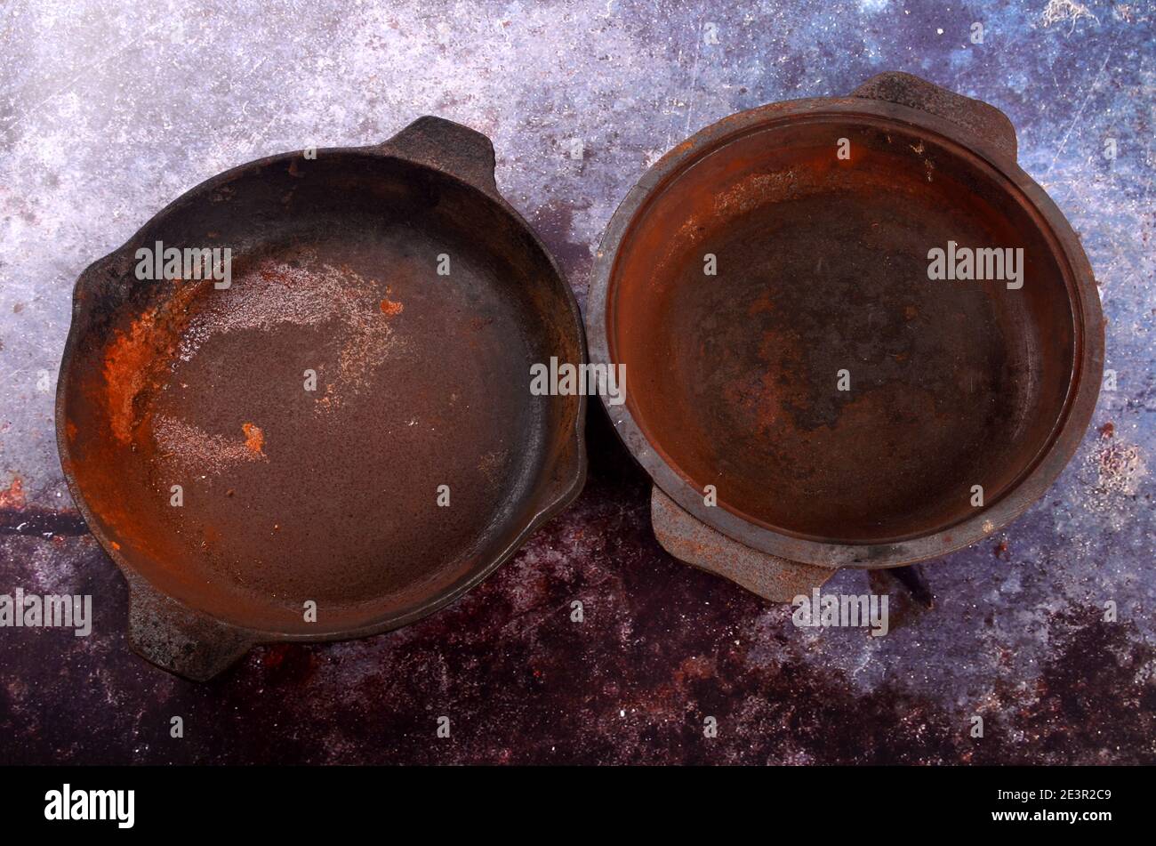 Rusty metal pans on a rustic background. Renovation of cast iron pan ...