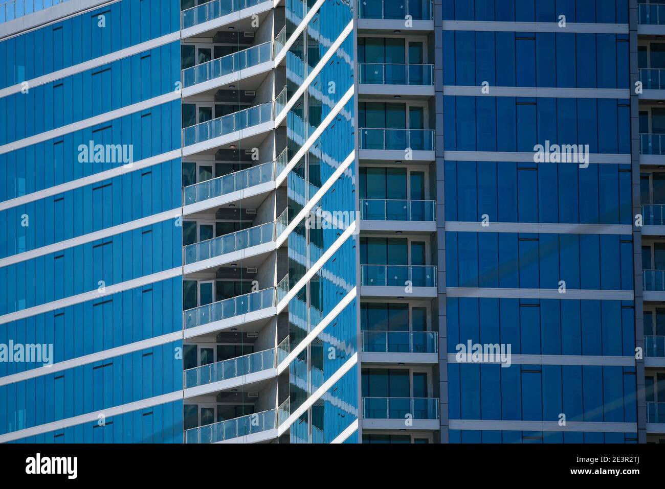 Corporate offices high-rise building blue glass facade with symmetrical ...