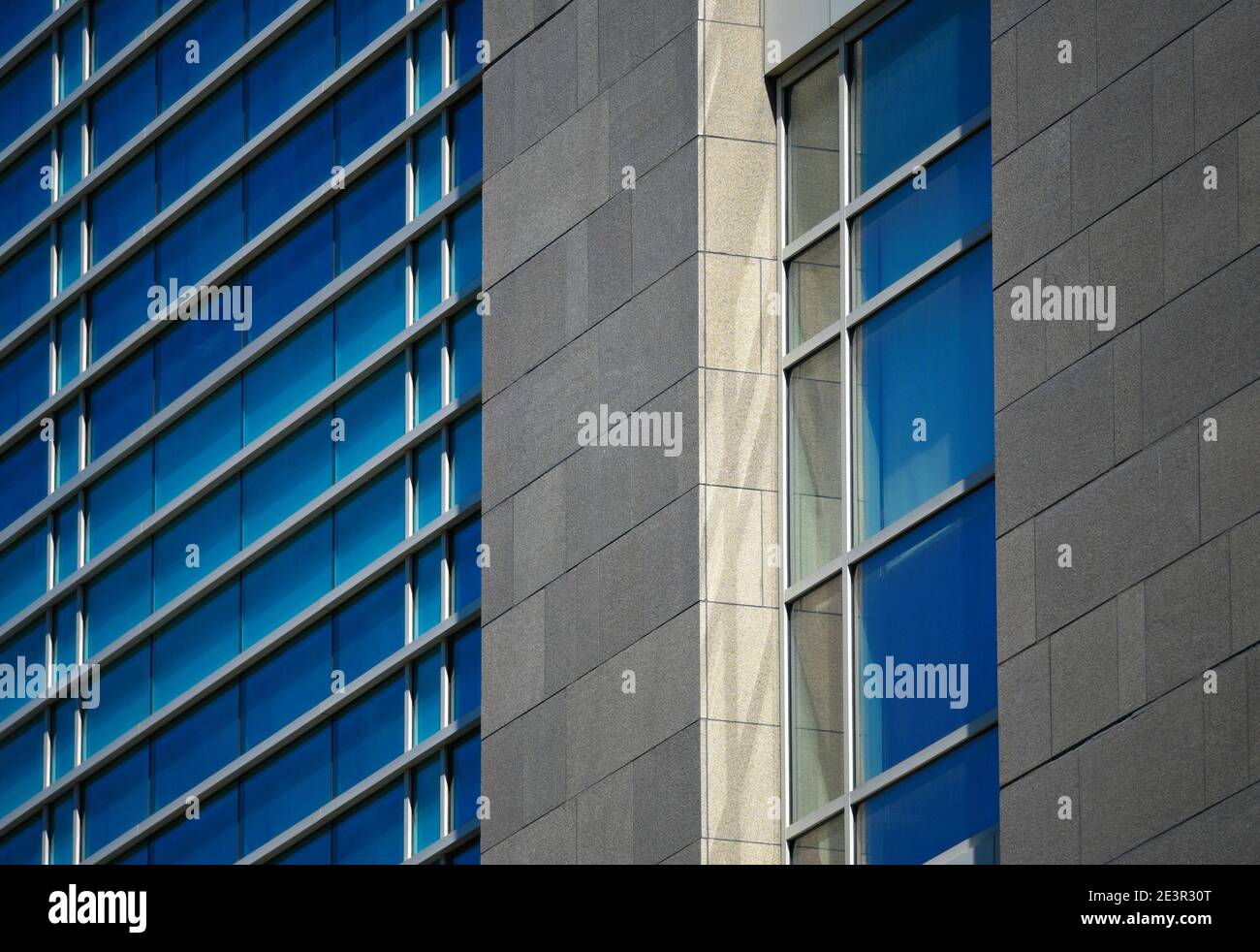 Corporate offices high-rise building exposed concrete and glass facade ...