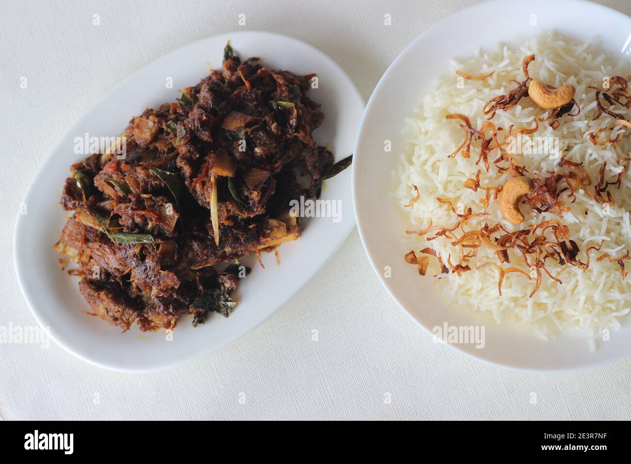 Aromatic traditional Ghee rice and spicy mutton roast prepared in ...