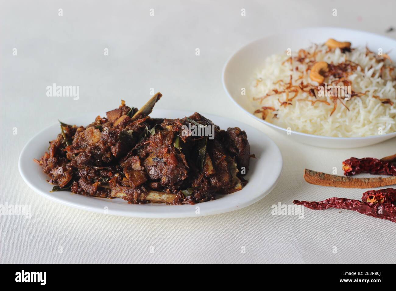 Aromatic traditional Ghee rice and spicy mutton roast prepared in ...