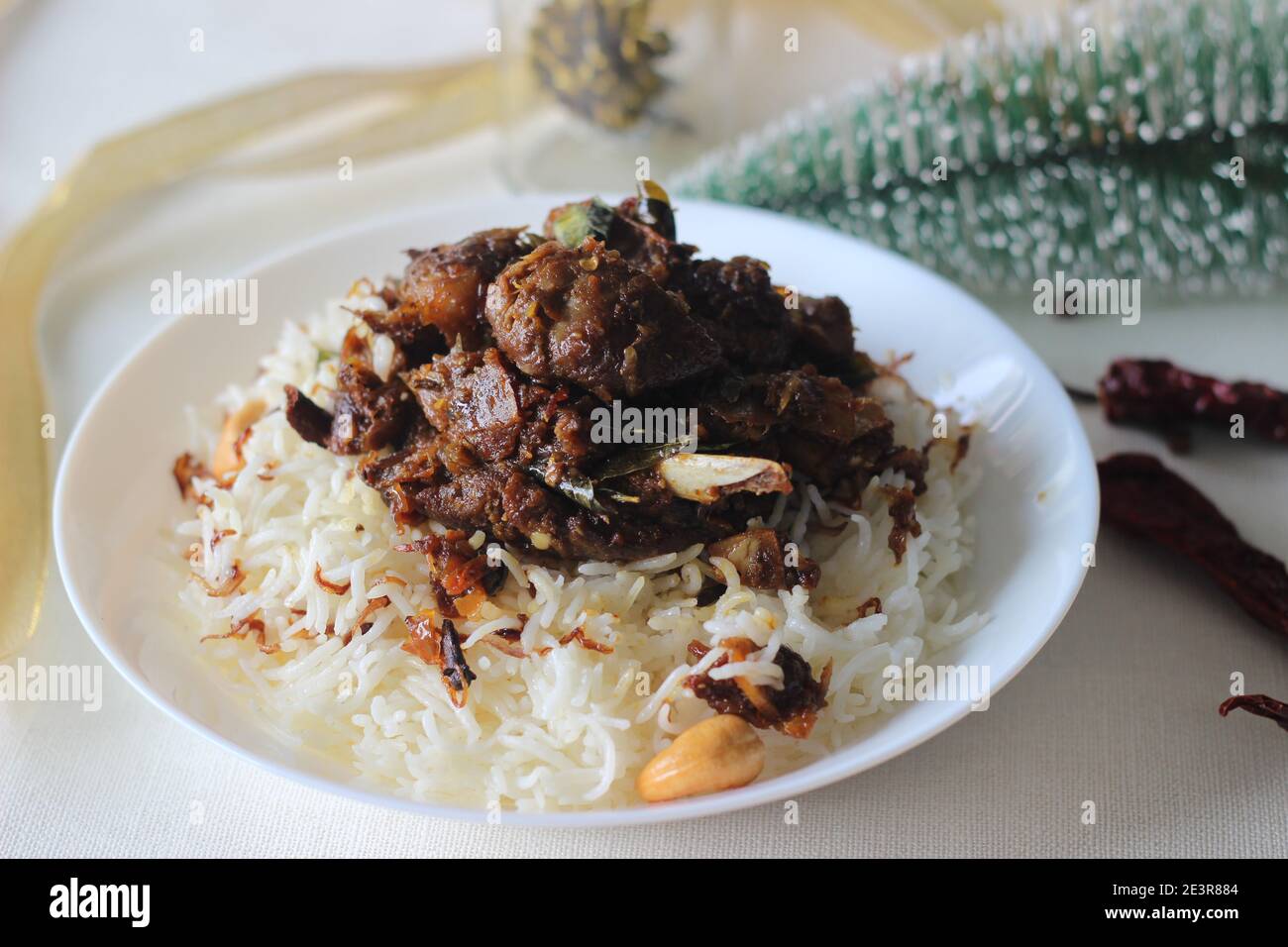 Aromatic traditional Ghee rice and spicy mutton roast prepared in ...