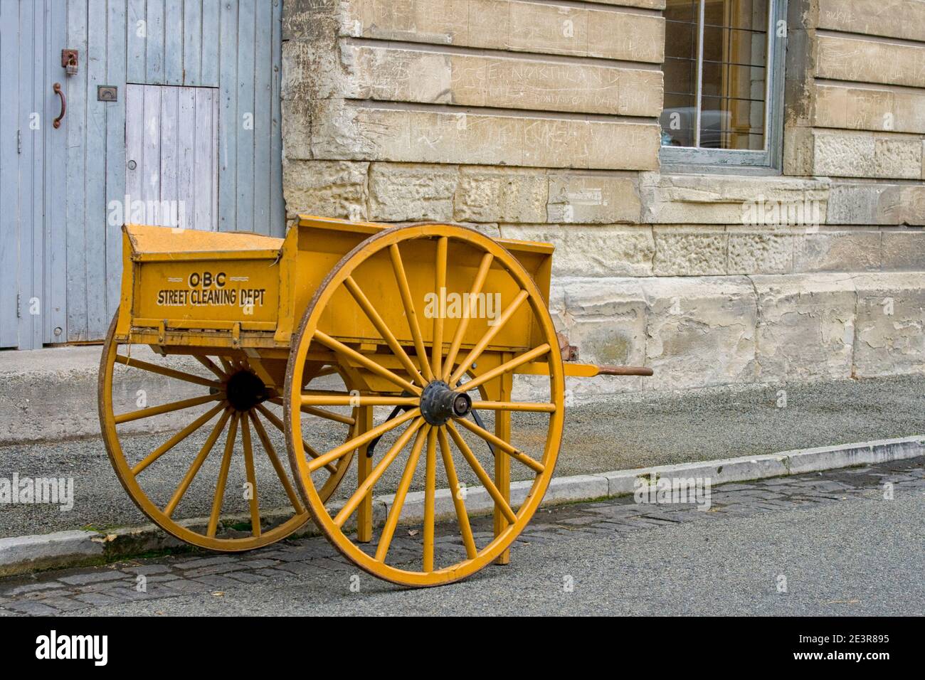 Vintage yellow push cart standing on street Stock Photo - Alamy