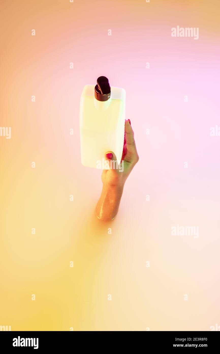 Cleaning. Close up female hand gesturing from the milk bath with soft ...