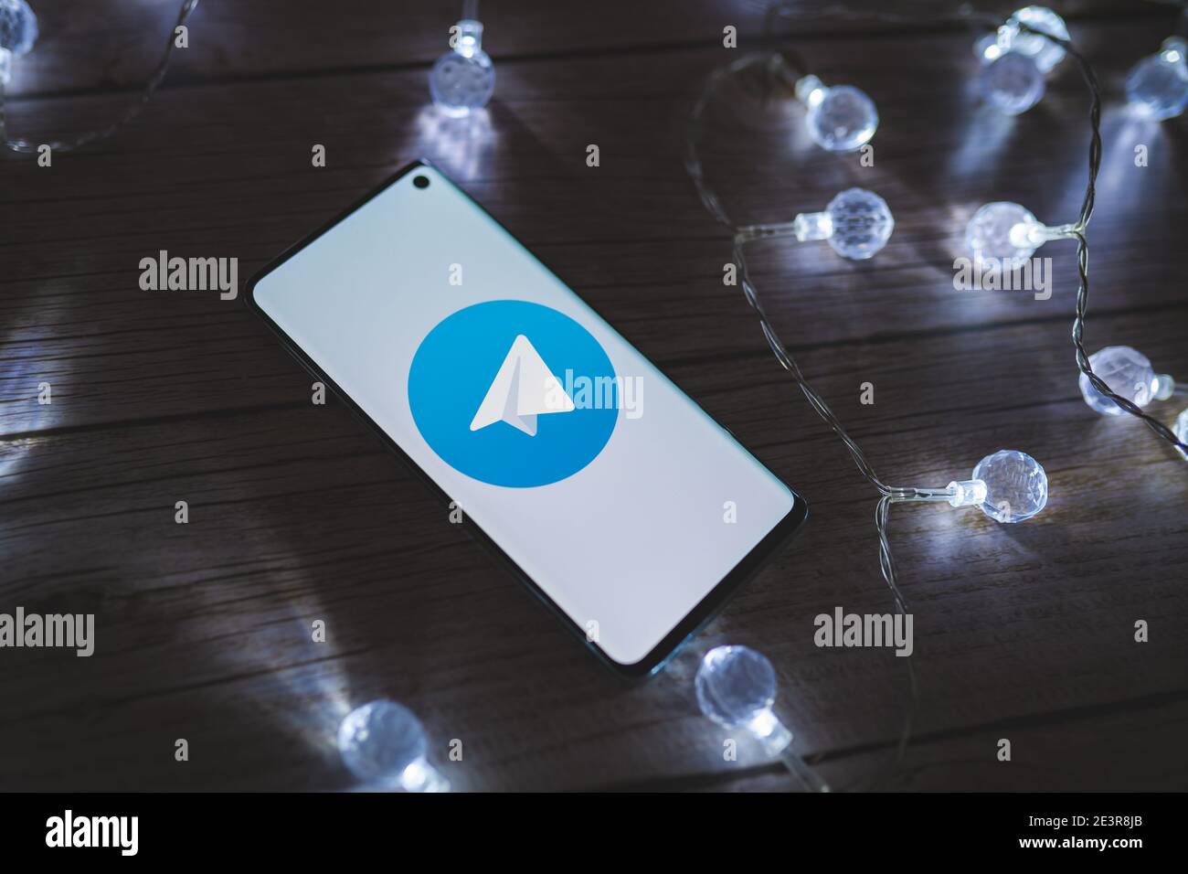 Smartphone with Telegram messenger logo displayed on the screen laying ...