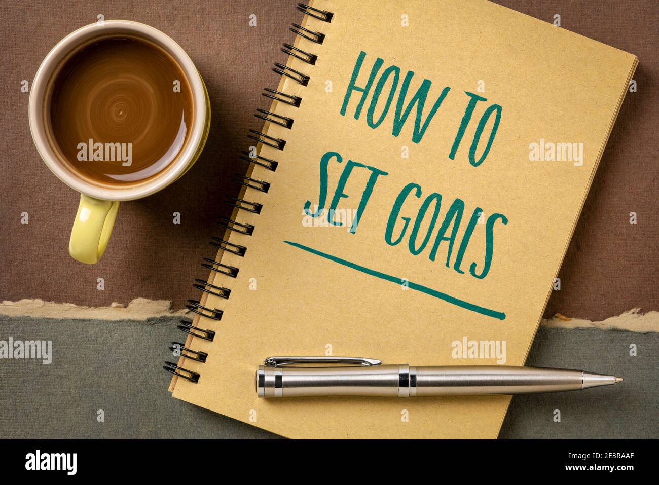 How to set goals - motivational handwriting in a spiral notebook with a ...