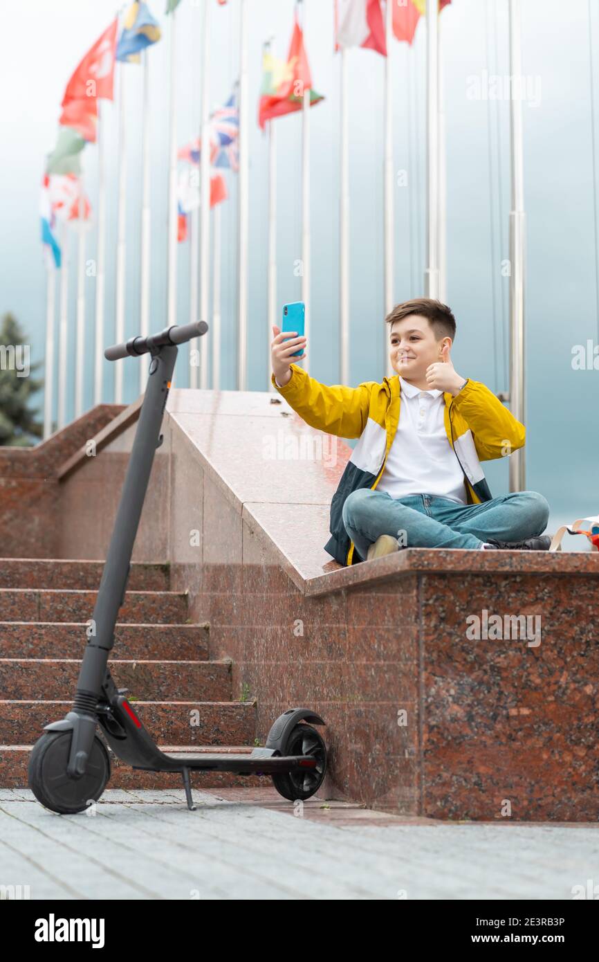 Teenager sits near the administration building against background of ...