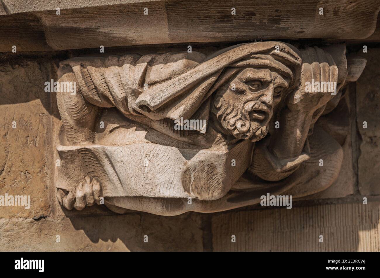 Decorative sculpture in human format on a gothic building in Ghent. A ...