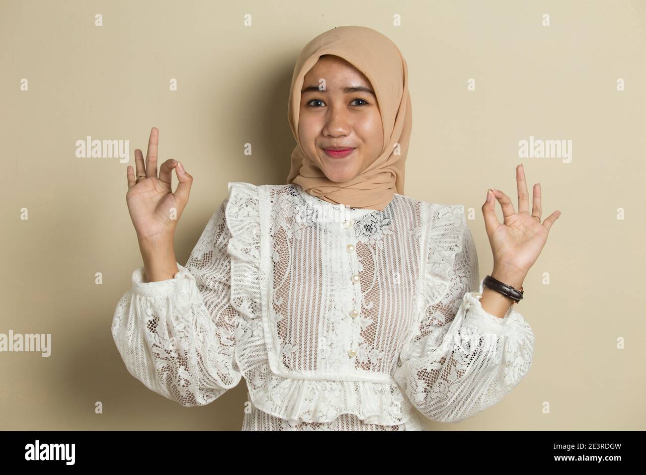 Asian muslim woman wearing hijab with ok sign gesture Stock Photo - Alamy