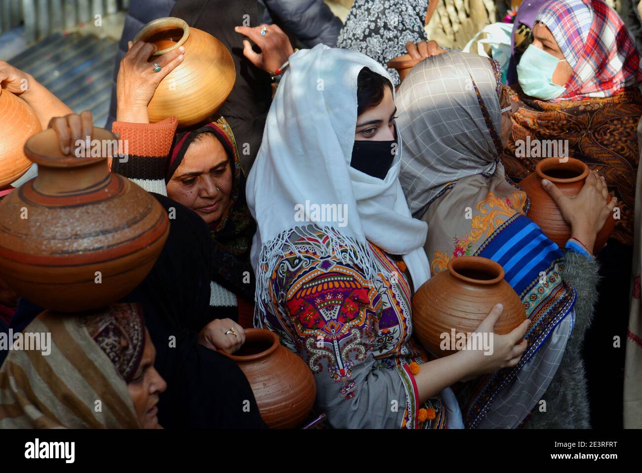 Pakistani women devotees bringing water for ablution of the graves at ...