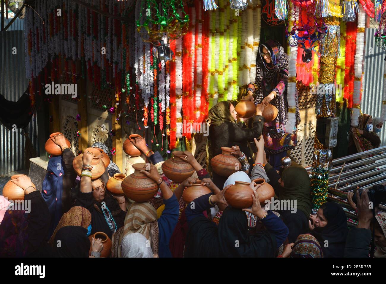 Pakistani women devotees bringing water for ablution of the graves at ...