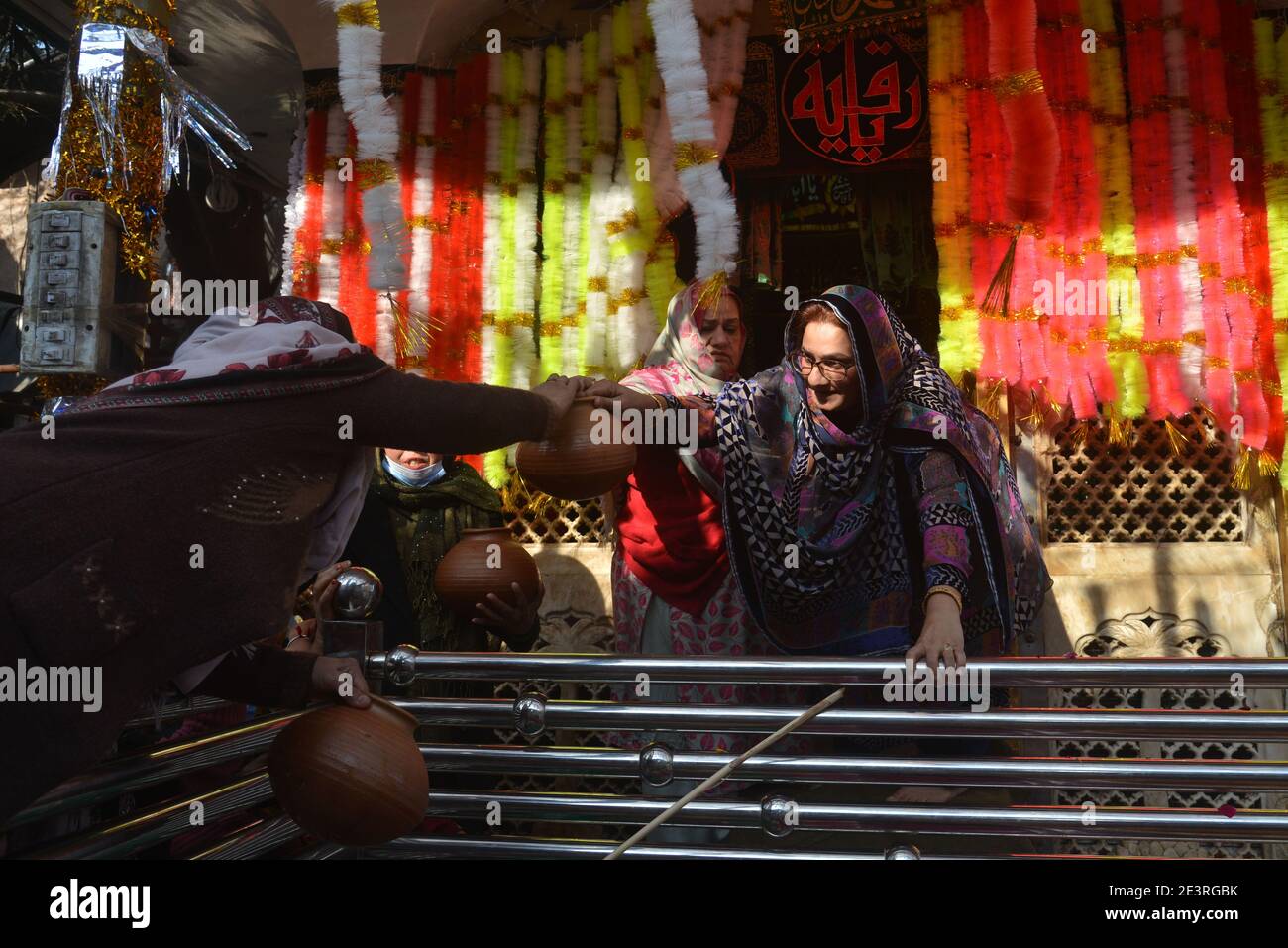 Pakistani women devotees bringing water for ablution of the graves at ...