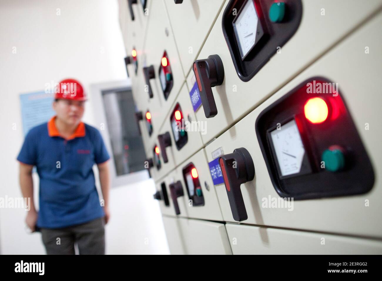 Electrical worker surveillance the electricity dial in the control room ...