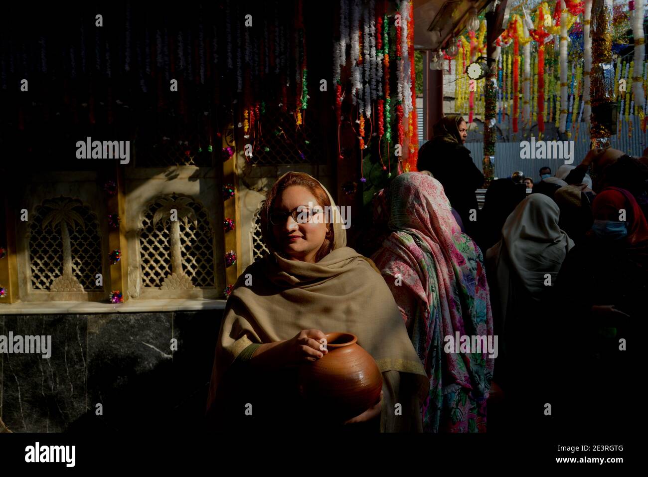 Pakistani women devotees bringing water for ablution of the graves at ...