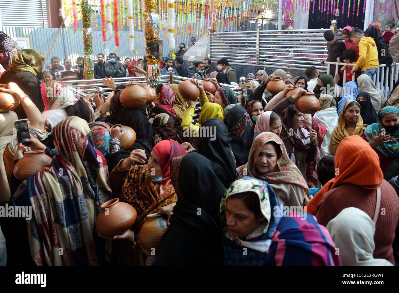 Pakistani women devotees bringing water for ablution of the graves at ...