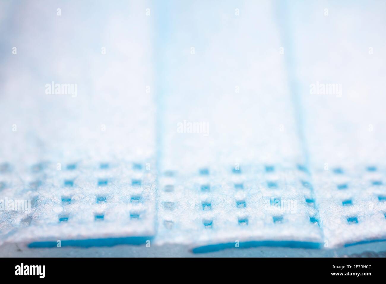 Protective, disposable light blue face mask. Extreme close-up macro ...