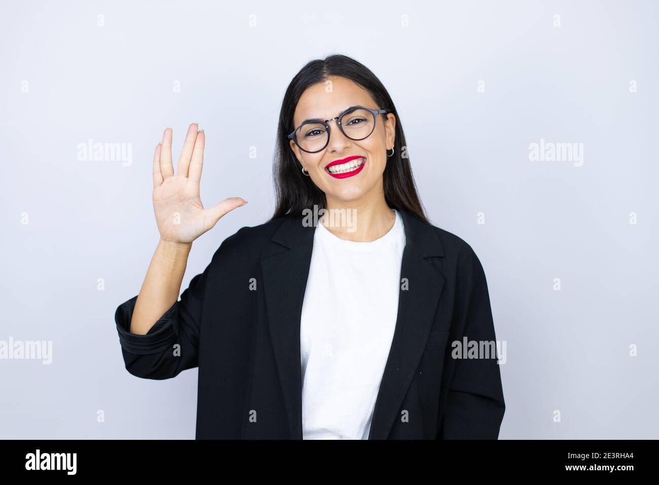 Beautiful business woman doing star trek freak symbol Stock Photo - Alamy