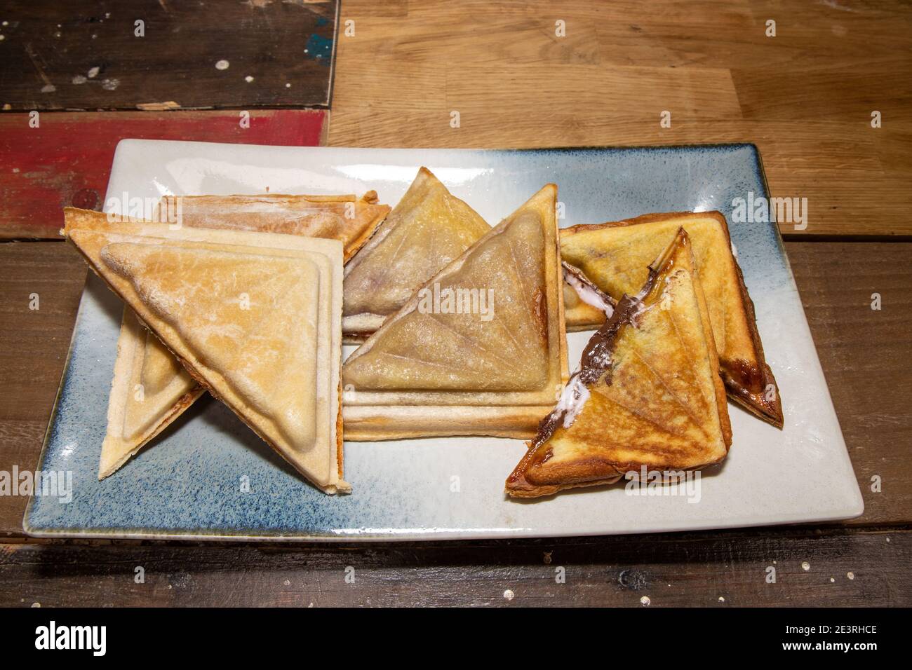 A pile of classic British toasties on a wooden kitchen table Stock ...