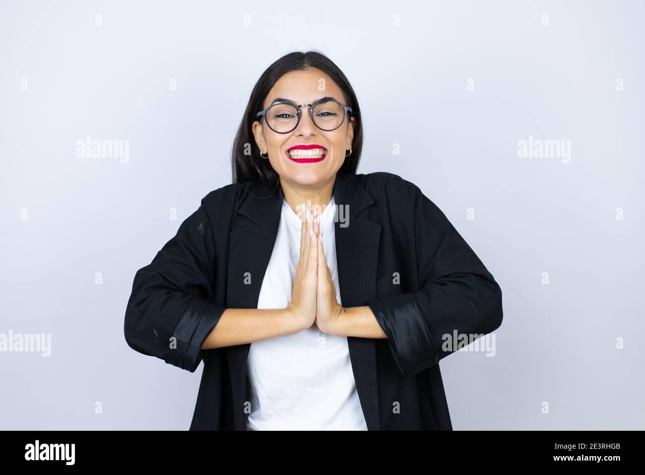 Beautiful business woman begging and praying with hands together with ...