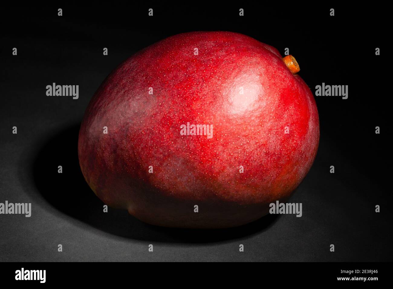 red mango on black background Stock Photo - Alamy