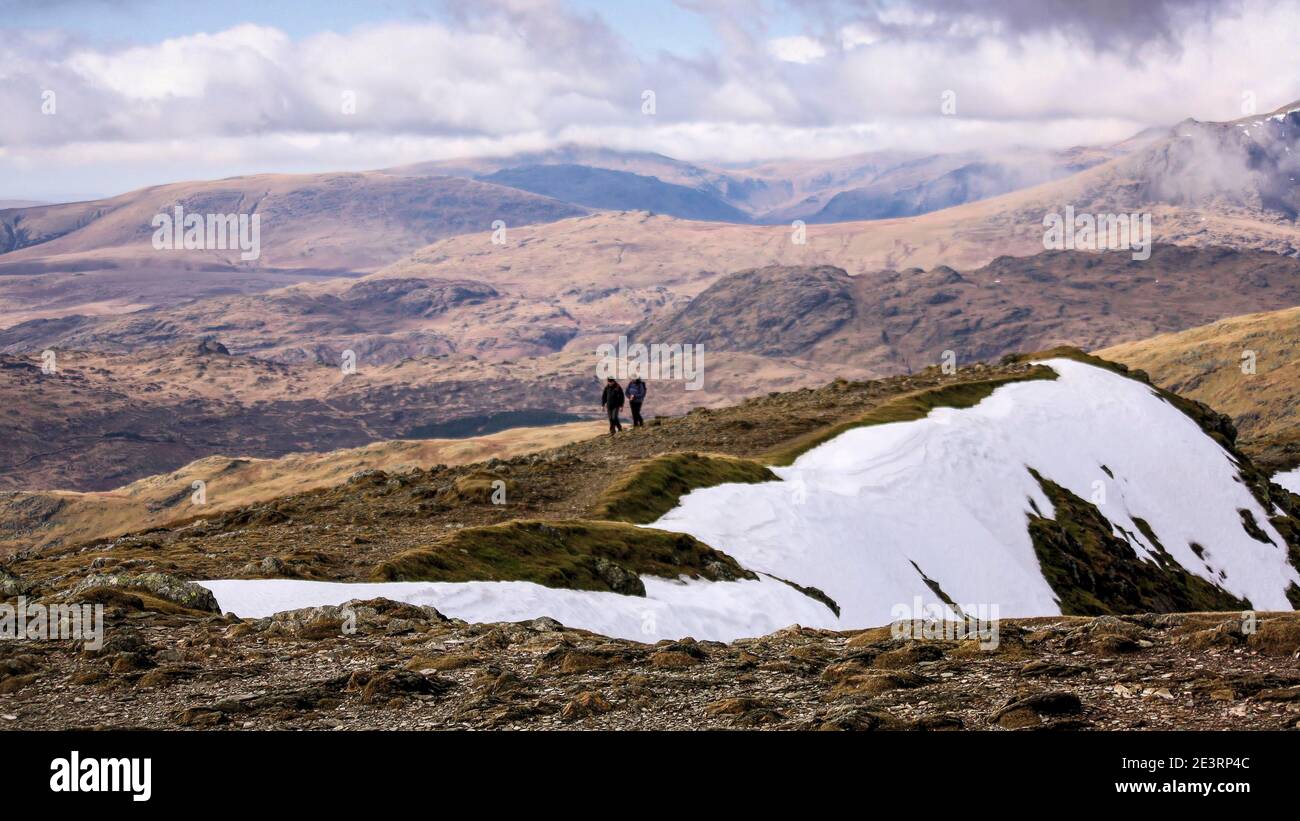 Rambling across Coniston Old Man in the clouds Stock Photo - Alamy
