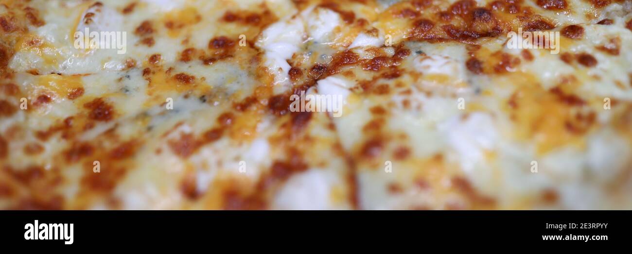 A large traditional pizza cut into slices close up Stock Photo - Alamy