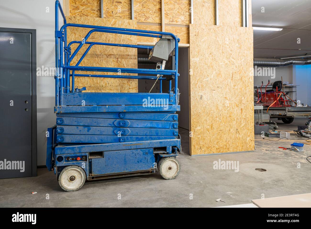 View of on working place with scissor lift. Construction work concept ...
