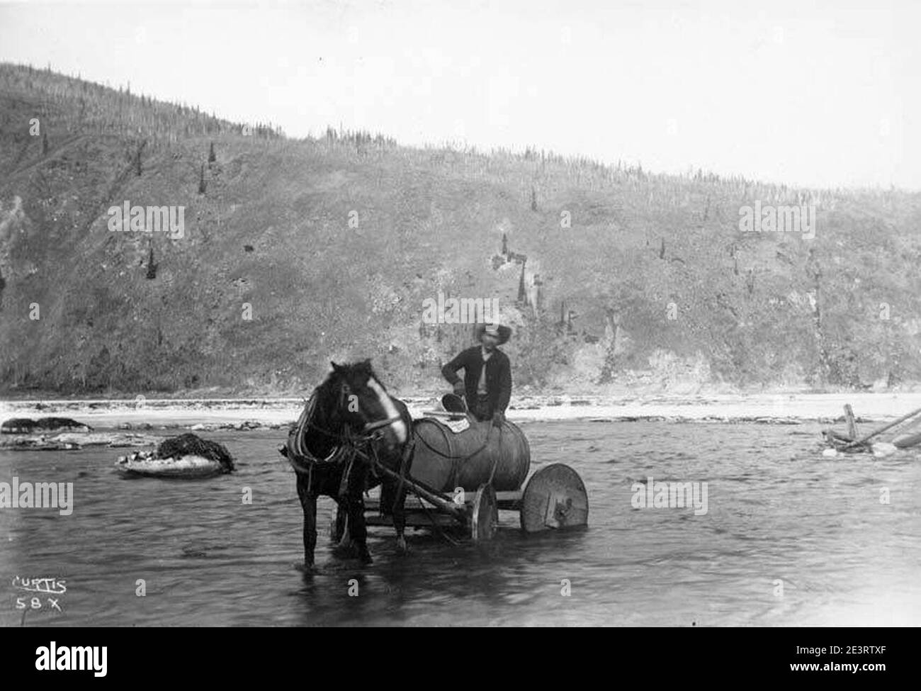 Man, identified as Borrick, in a horse driven water wagon, Yukon ...
