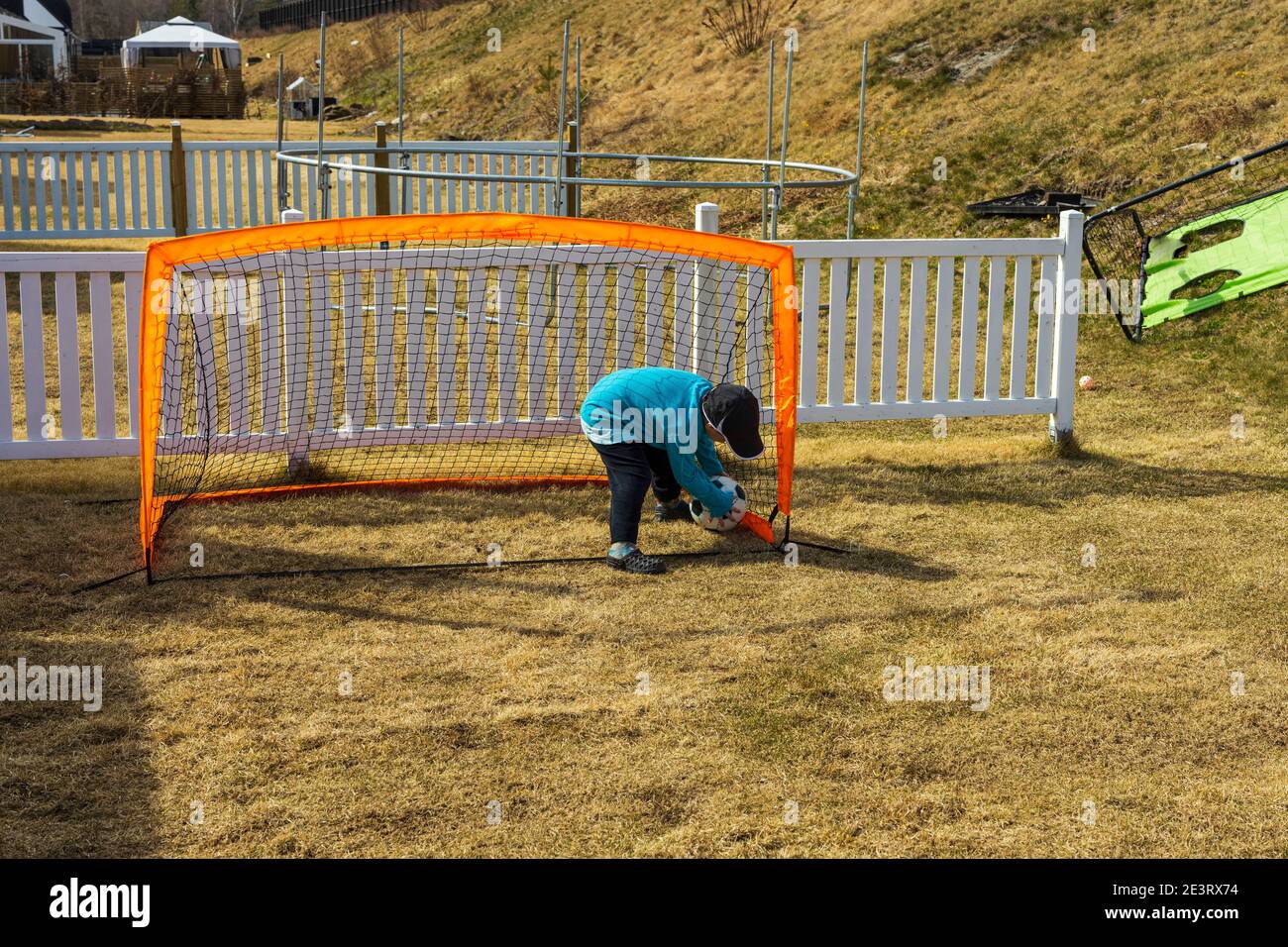 Close up view of boy playing football on backyard. Outdoor games ...