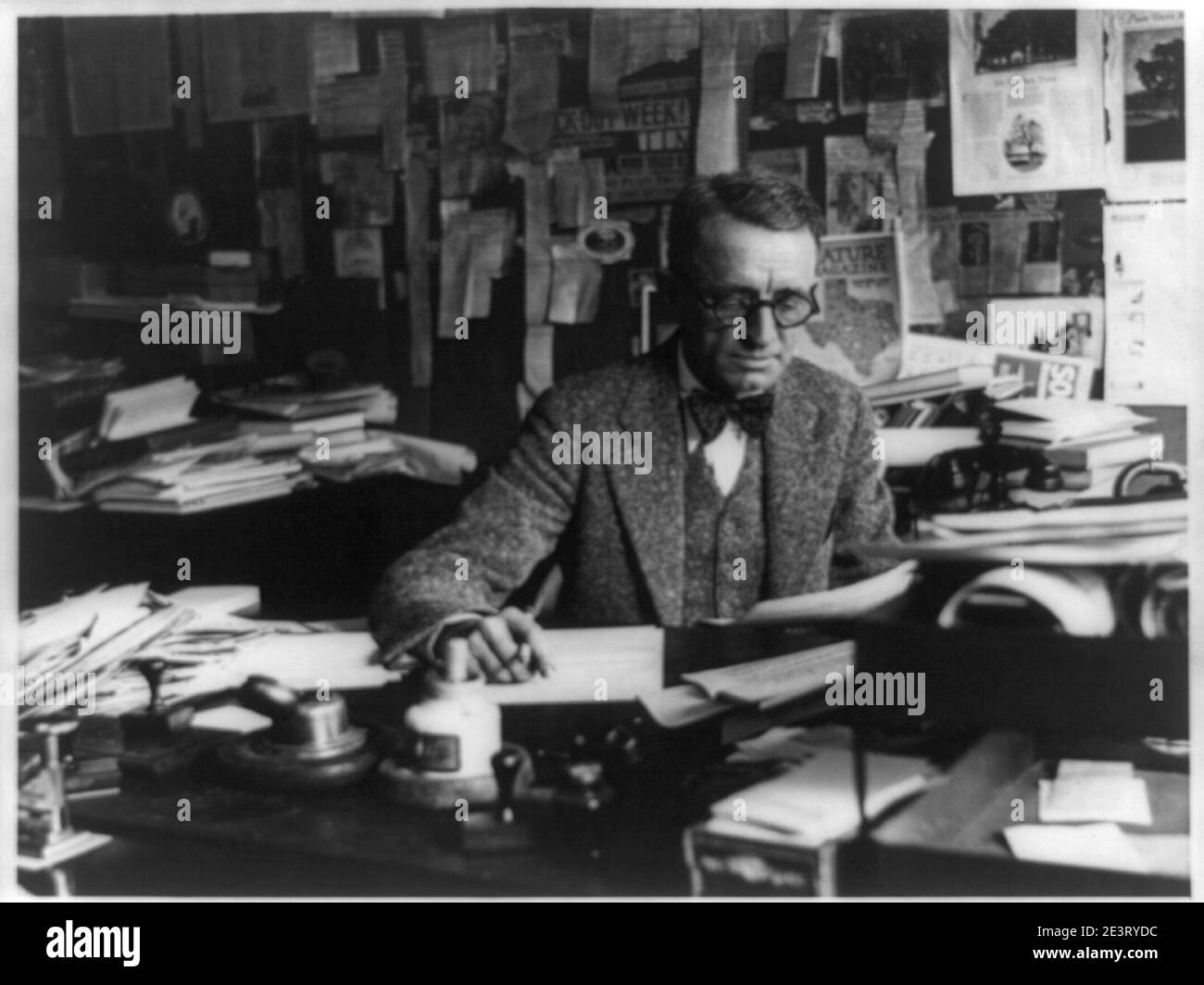 Man at desk reading typewritten pages Stock Photo - Alamy