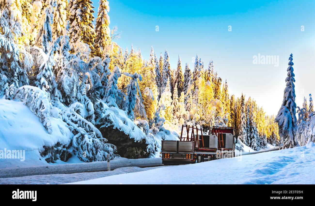 Truck driving on a highway through a wild arctic woodland Stock Photo ...