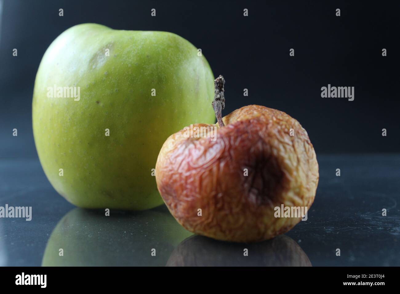 apple ugly spoiled and beautiful good on a black background copyspace ...