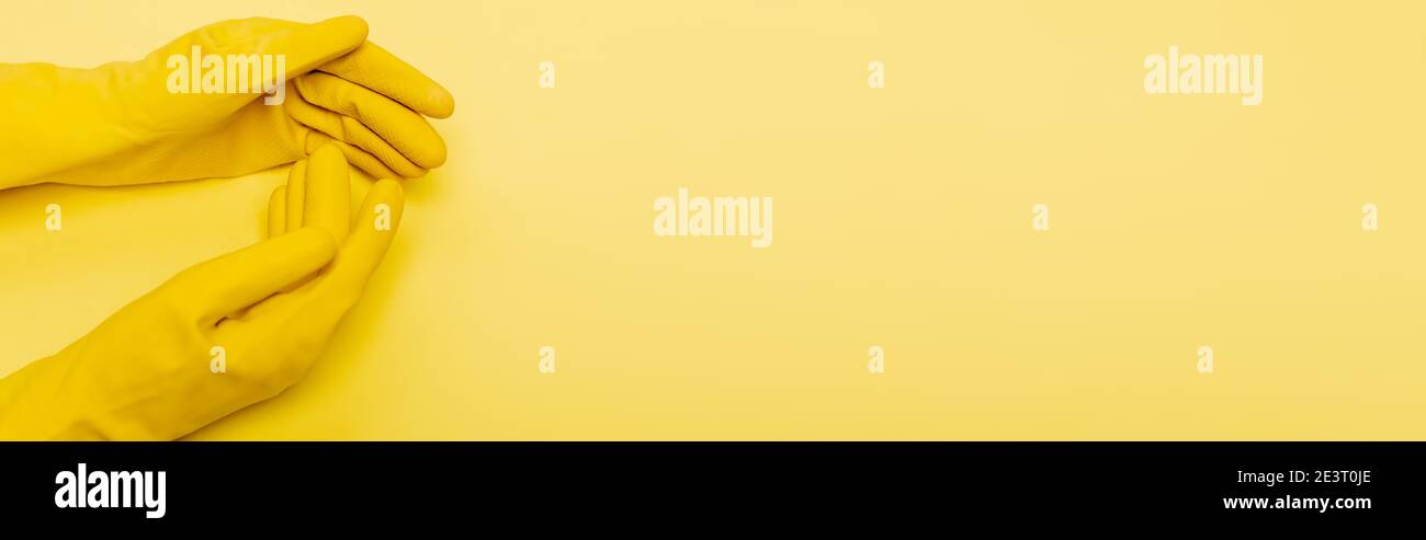 Top view of hands in rubber gloves on yellow background, banner Stock ...