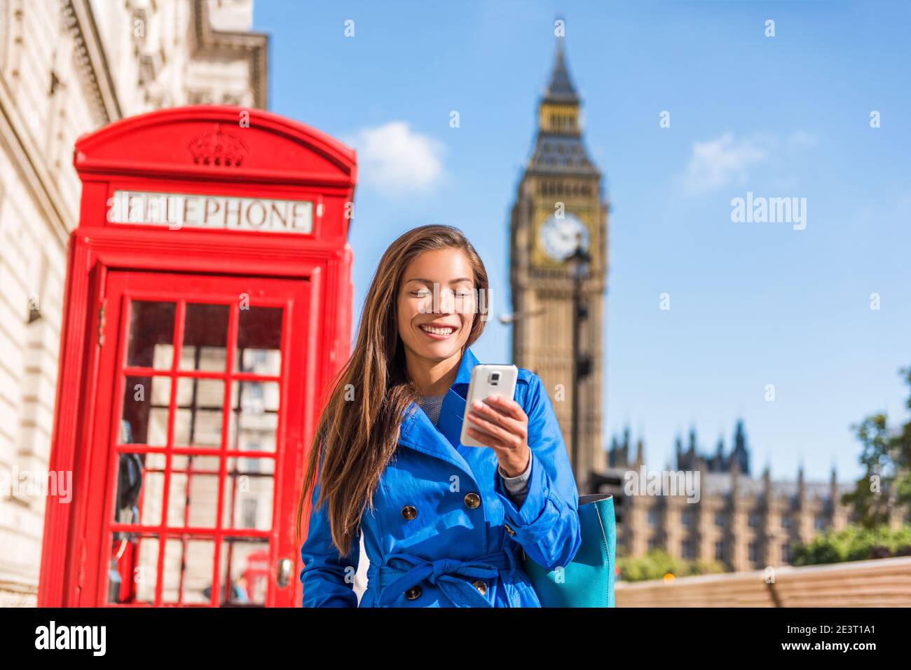 London mobile phone business Asian woman writing text message using ...