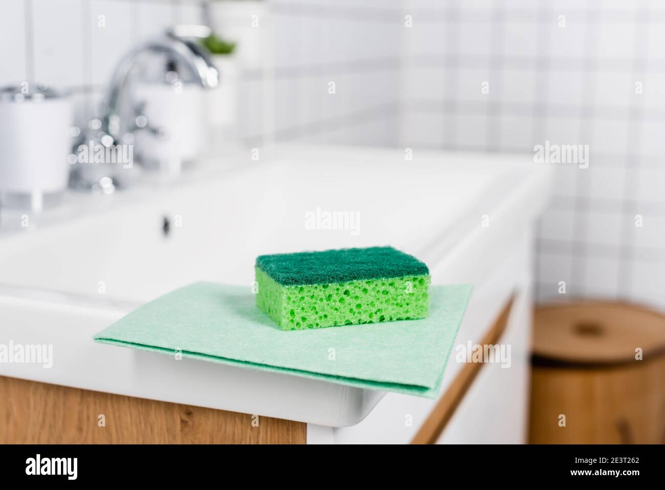Sponge and rag on sink on blurred background in bathroom Stock Photo ...