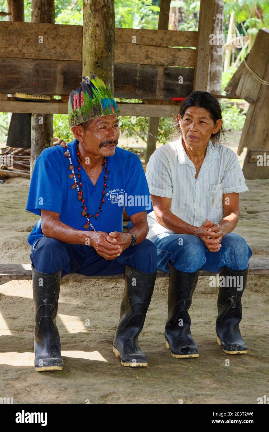 indigenous couple, Shaman wearing feathered headdress, wife, tall ...