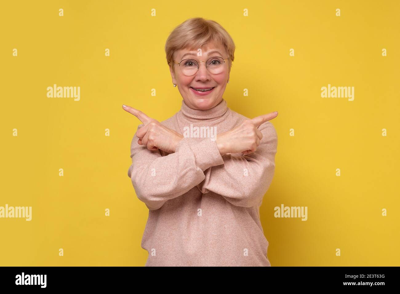 Smiling aged senior lady compare two options, happy positive mature ...