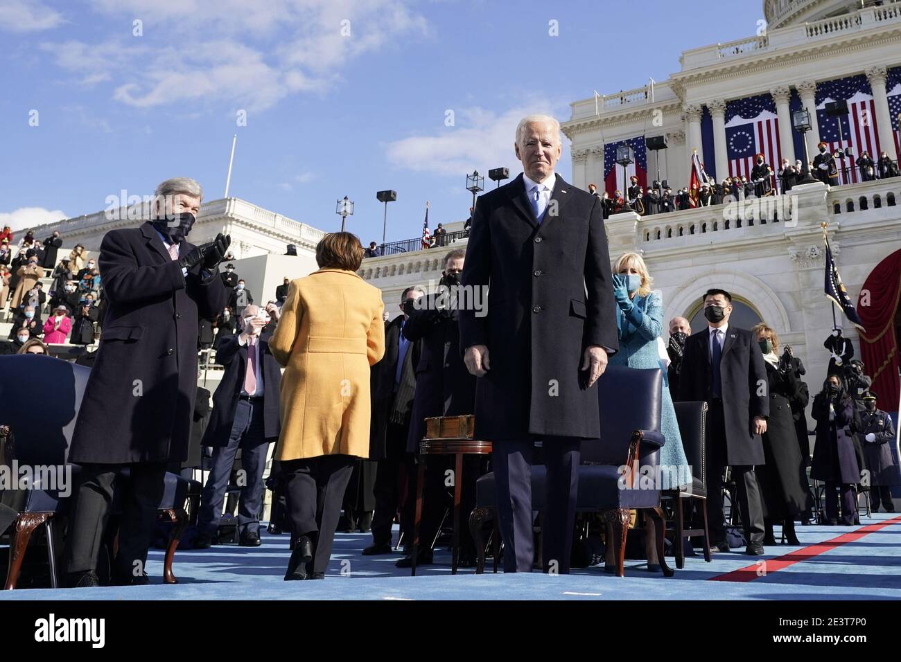 President Joe Biden stands after he was sworn-in during the 59th ...