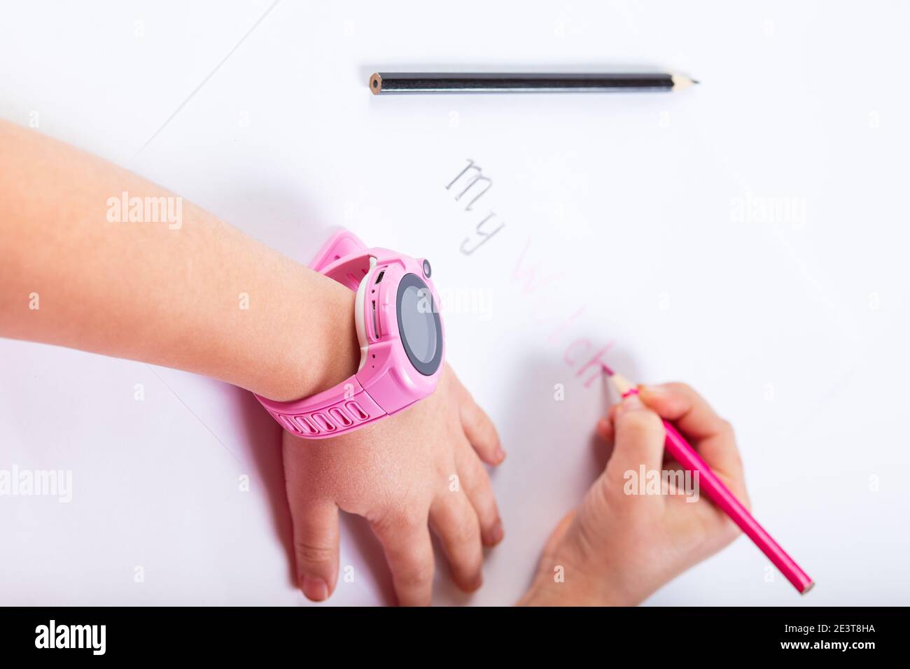 Children's hands write with pencils the word my watch on a white ...