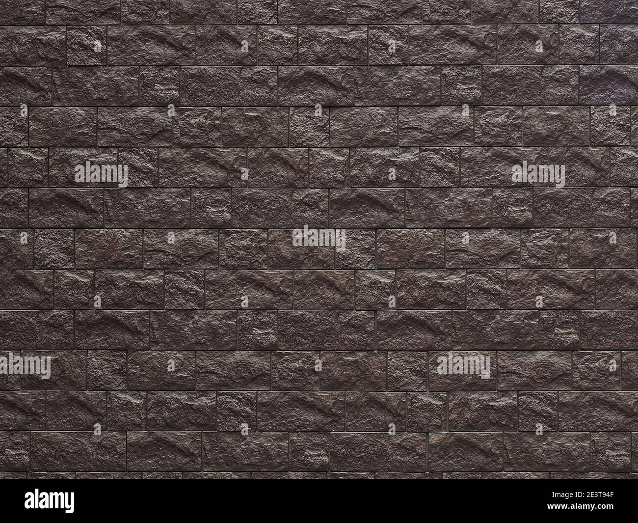 Wall with brown decorative cladding with textured granite tiles. Not ...