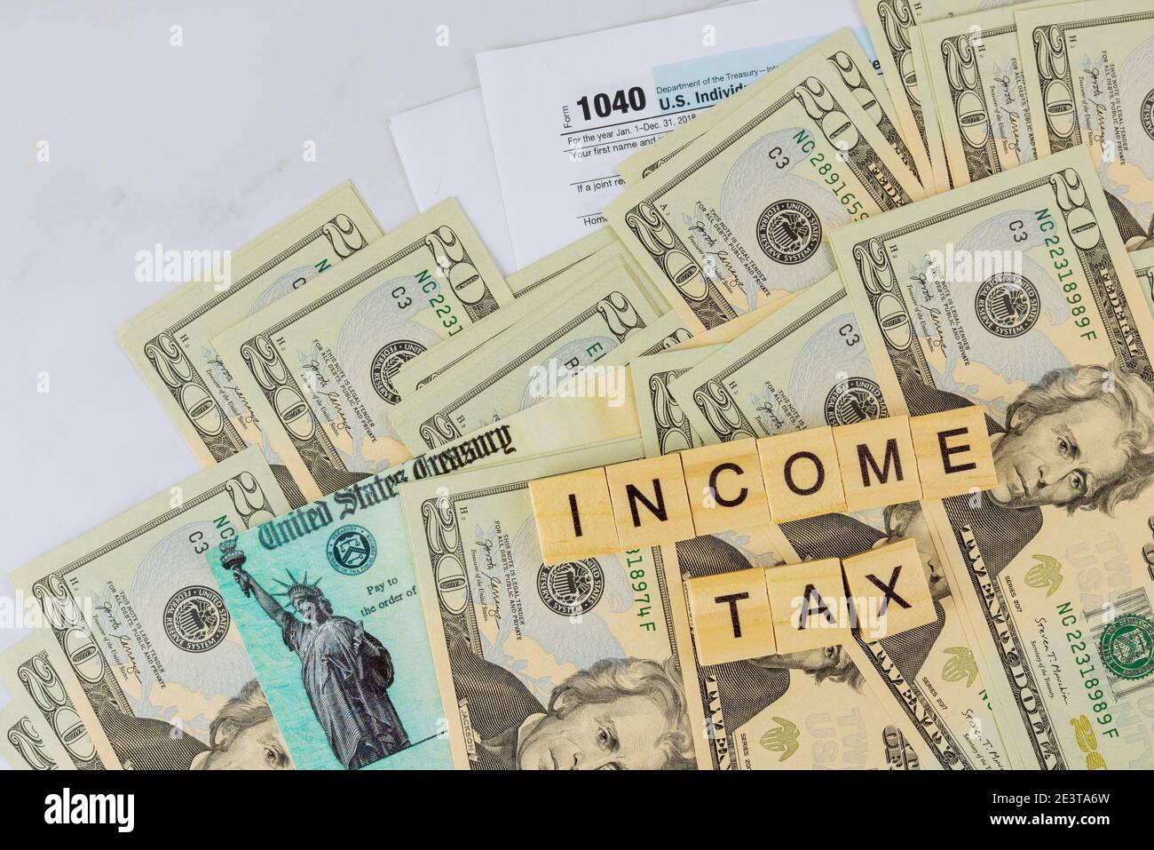 IRS form 1040 with individual income tax return of dollar bills ...