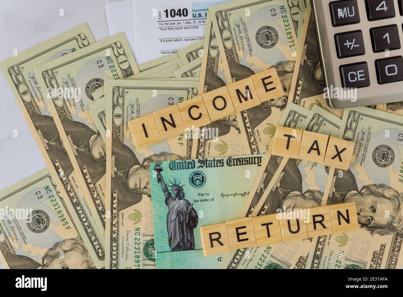 Income tax return US tax form 1040 on dollar bill desk, with calculator ...