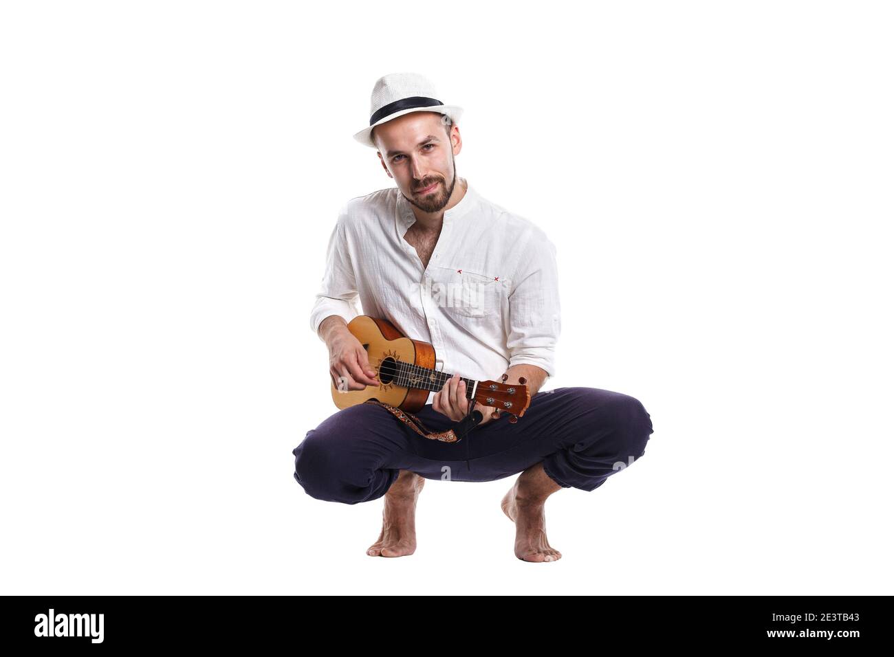 Attractive young Caucasian male with ukulele isolated on white ...