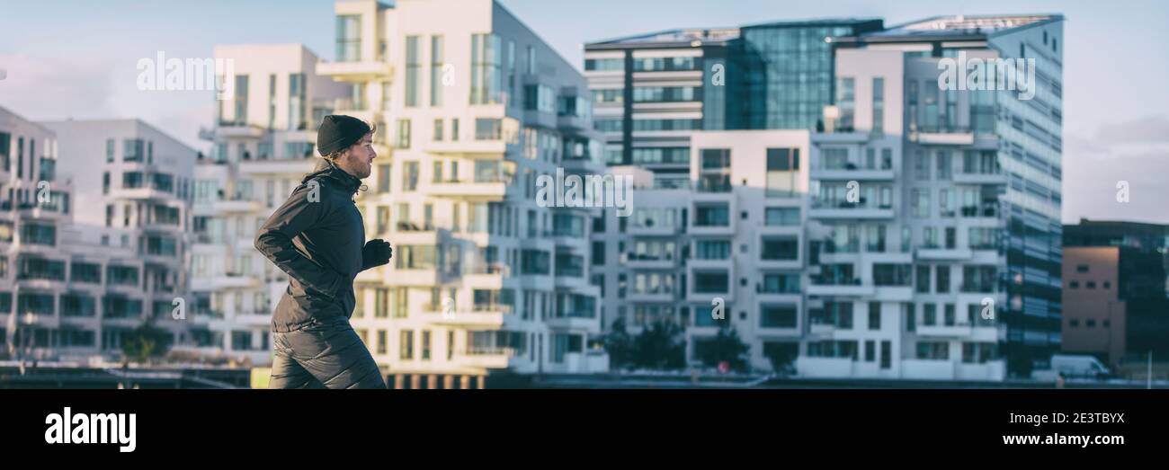 City lifestyle winter run runner athlete man jogging outside on modern ...