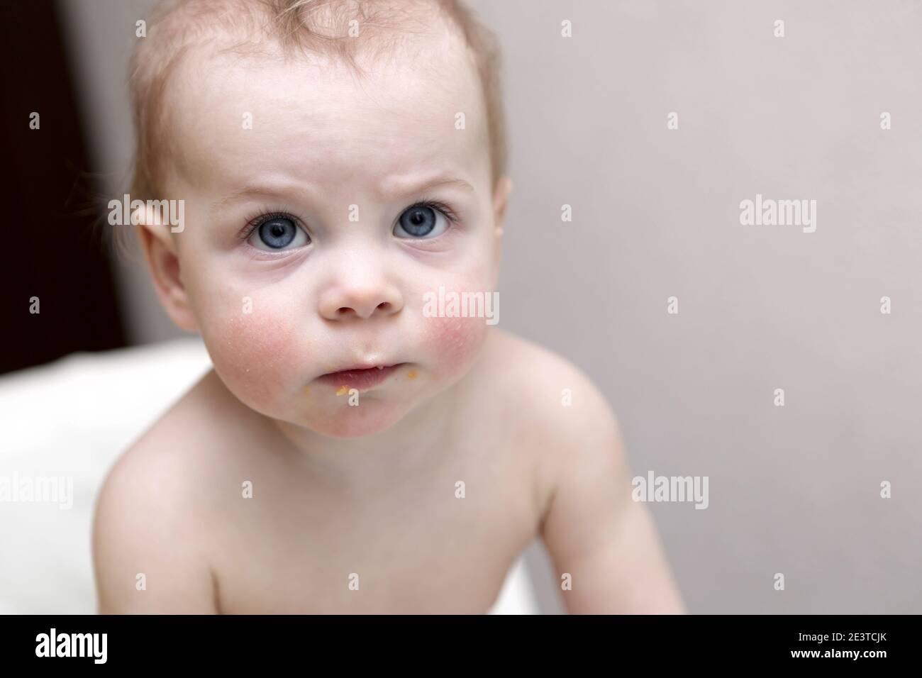 Portrait of a serious toddler on the wall background Stock Photo - Alamy