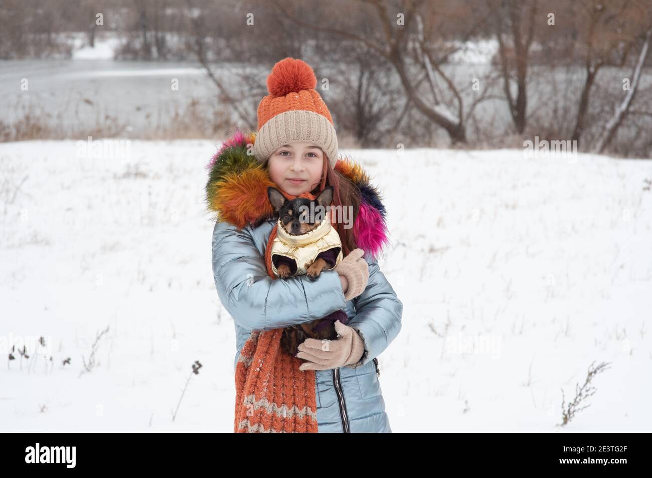 Winter portrait of young girl in her warm clothing. Teenage girl in a ...
